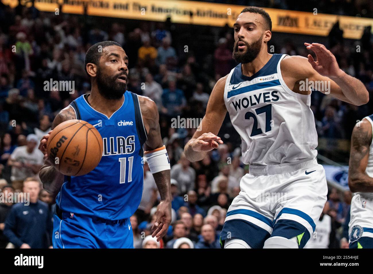 Dallas Mavericks guard Kyrie Irving (11) drives to the basket past Minnesota Timberwolves center ...