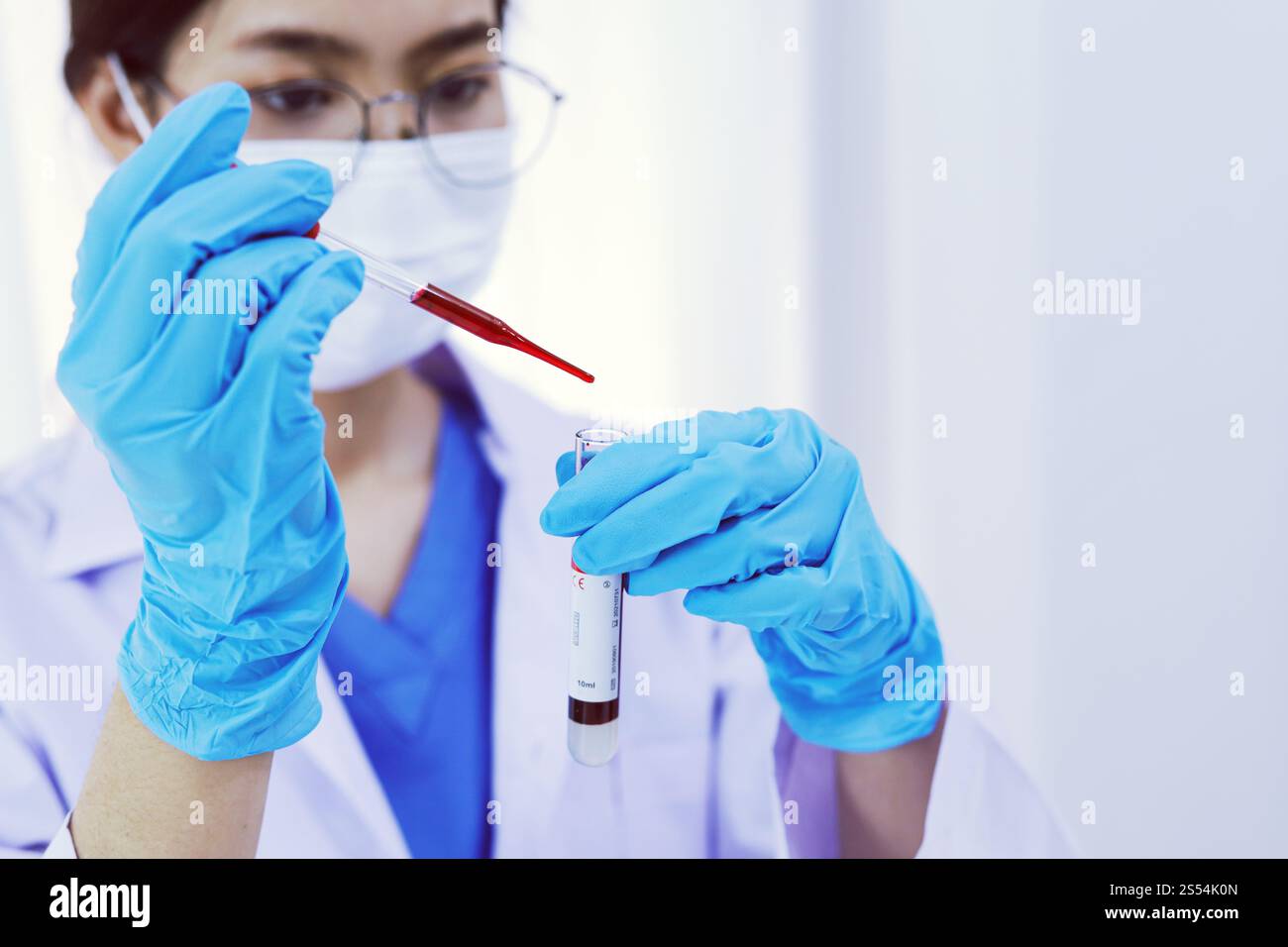 Scientist holding Coronavirus covid-19 infected blood sample tube. DNA ...