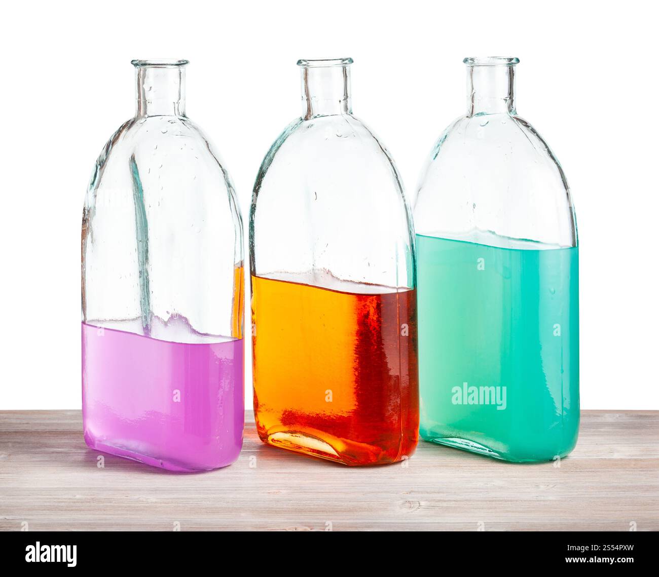 glass bottles with color watercolour solutions on wooden board with ...