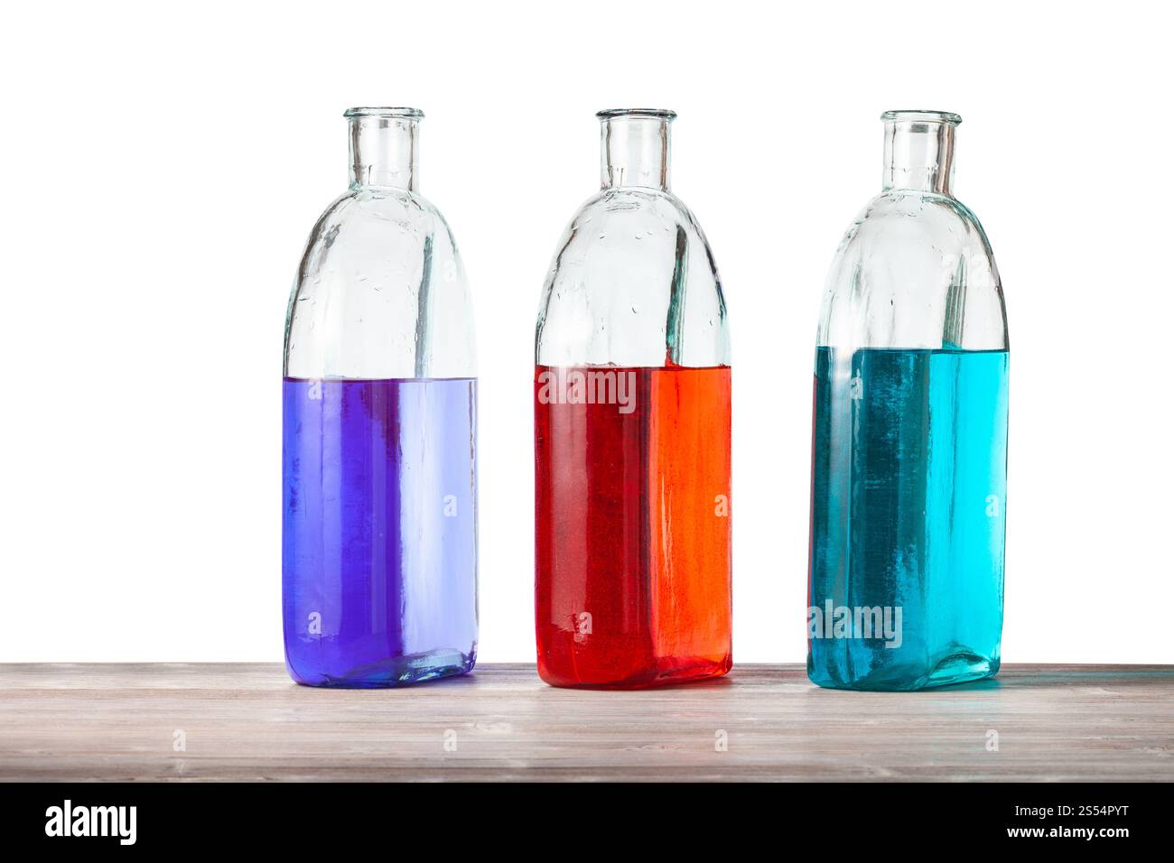 glass bottles with color ink solutions on wooden board with cutout ...