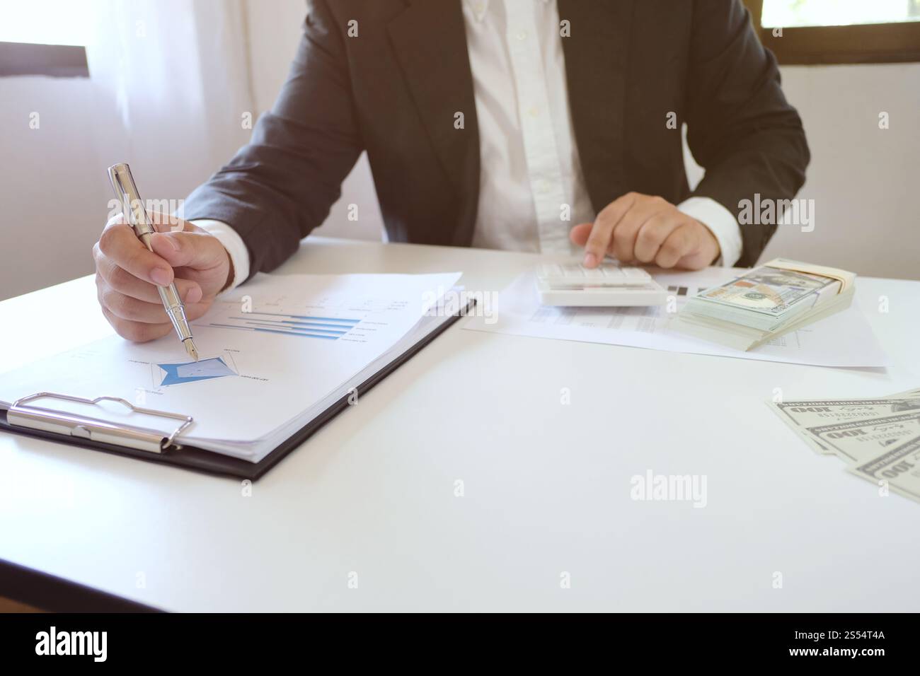 Accountant Working man uses calculator with Spreadsheet document ...
