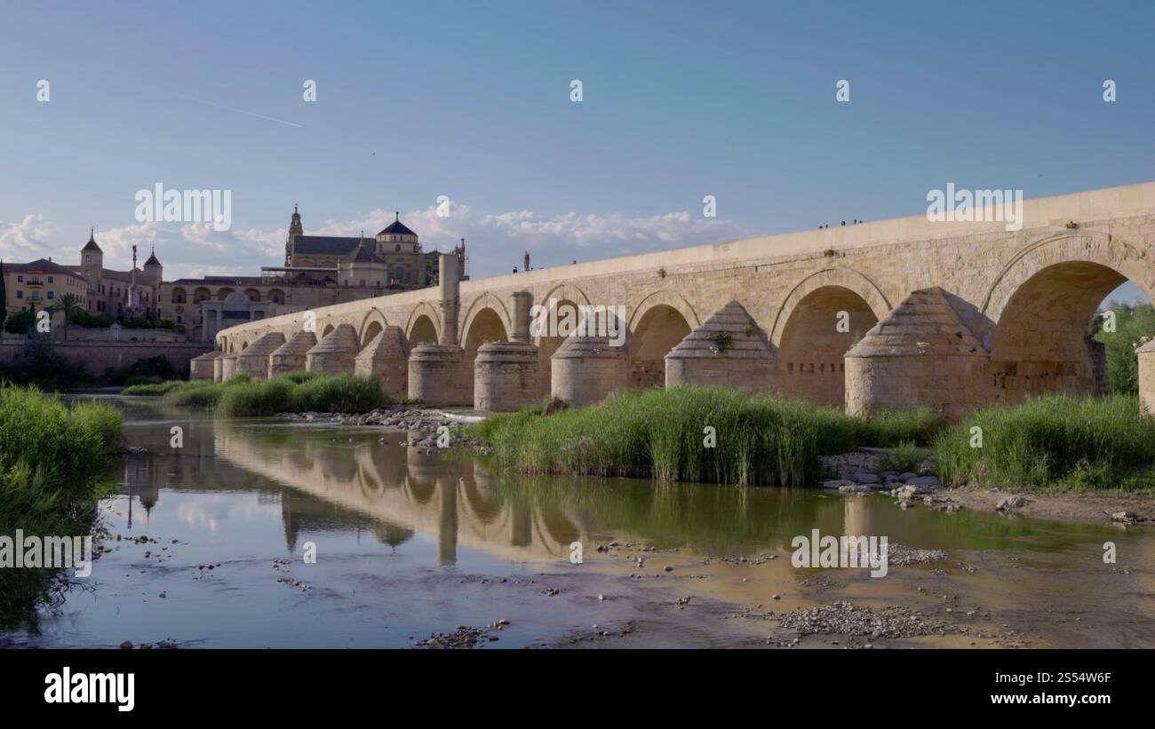 low angle view of the ancient roman bridge and the mosque of cordoba ...