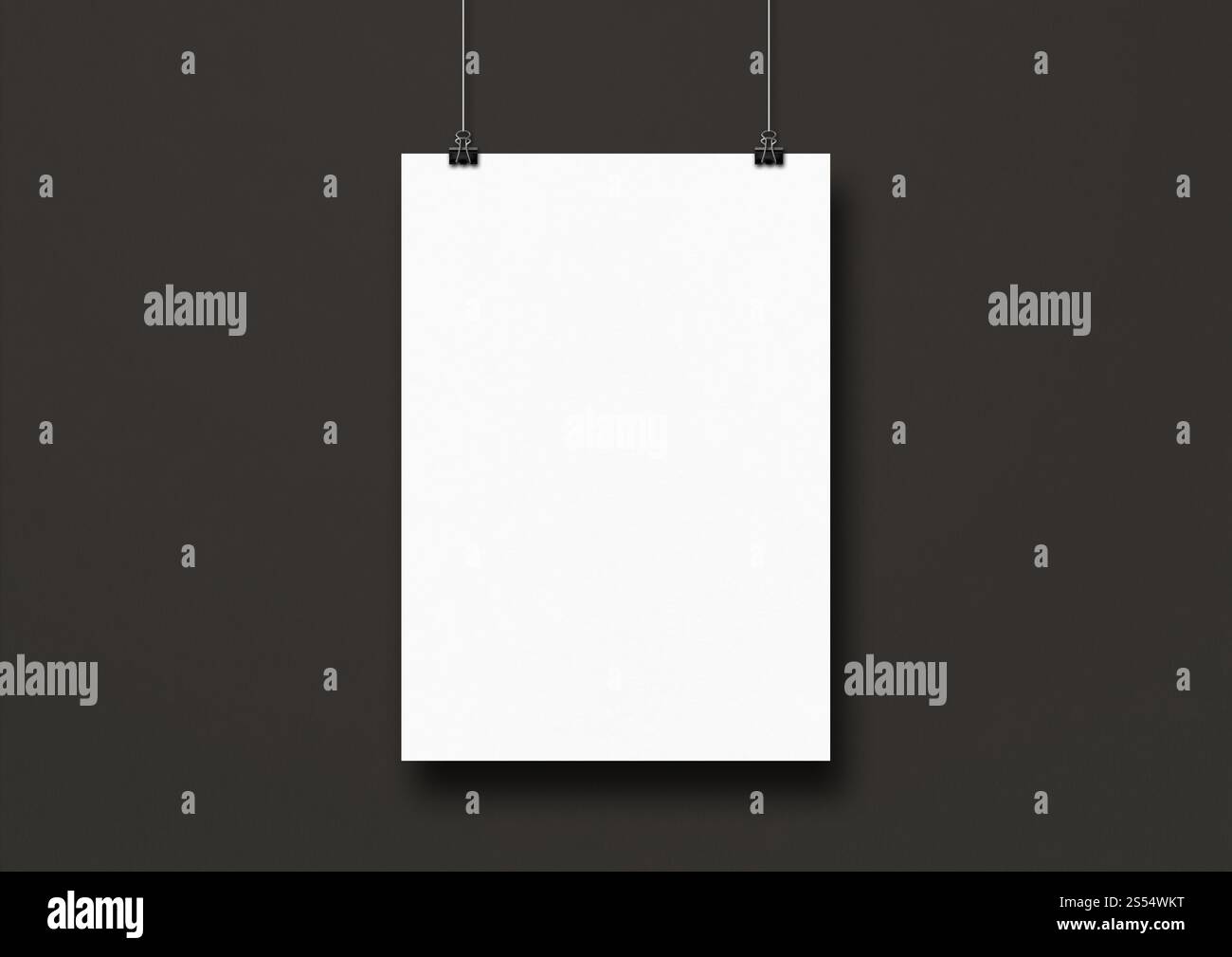 White poster hanging on a black wall with clips. Blank mockup template ...