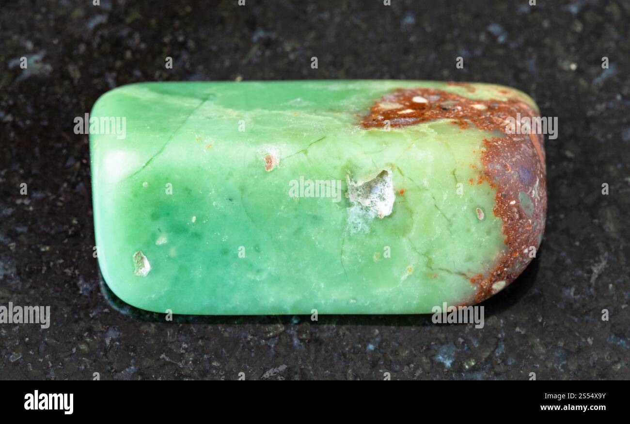 closeup of sample of natural mineral from geological collection - polished Chrysoprase rock on ...