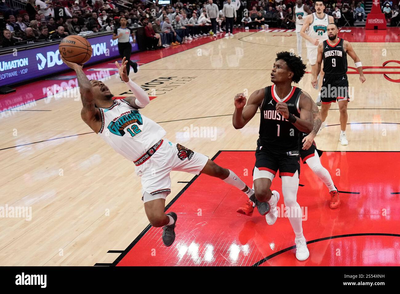 Memphis Grizzlies' Ja Morant (12) shoots as Houston Rockets' Amen Thompson (1) defends during ...