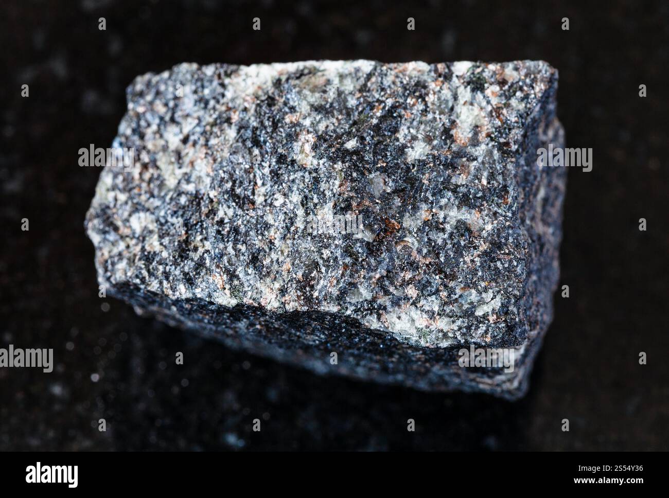 closeup of sample of natural mineral from geological collection - unpolished Nepheline Syenite ...