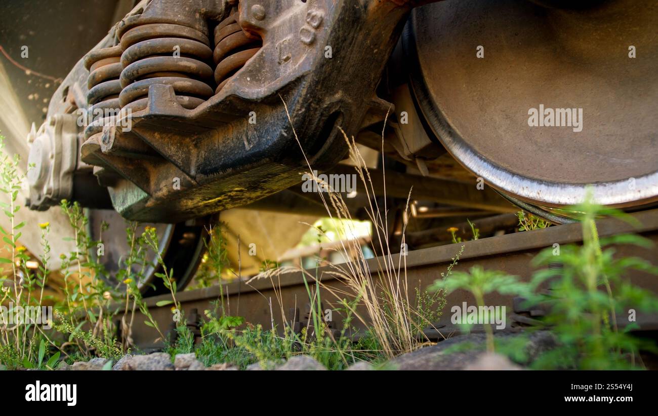 Closeup photo of old rusty train wagon wheels on abandoned railroad ...