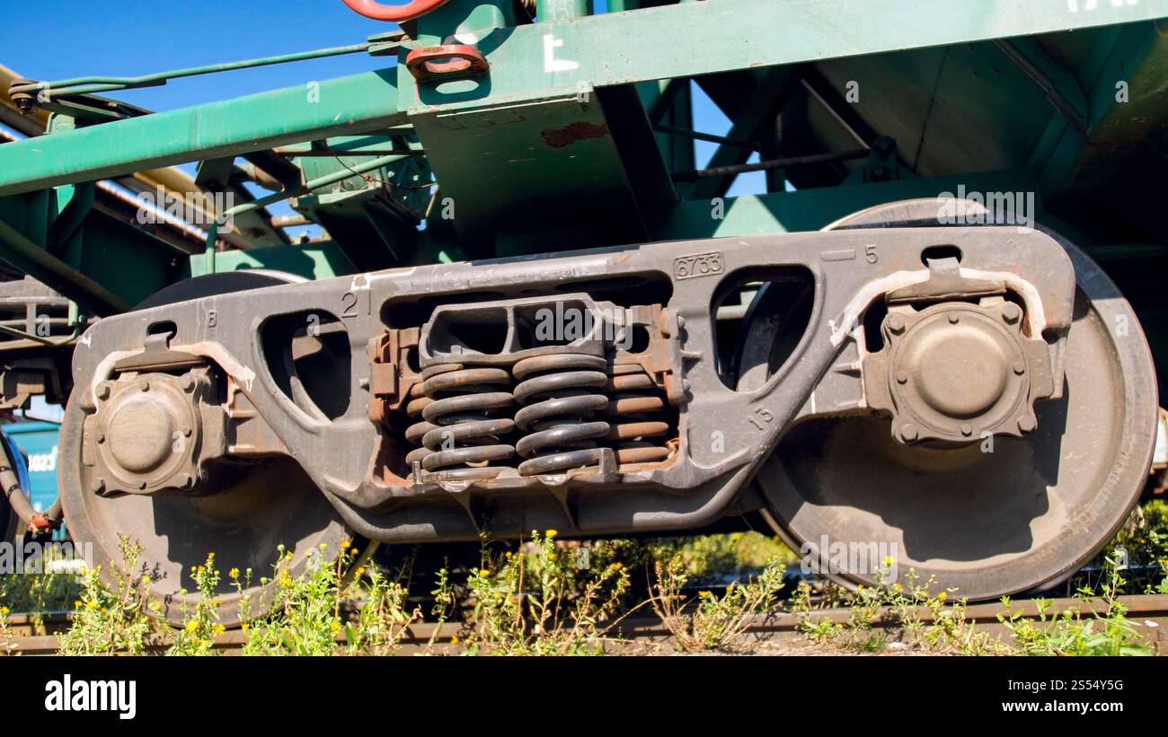 Closeup photo of suspension system and metal wheels on cargo train ...
