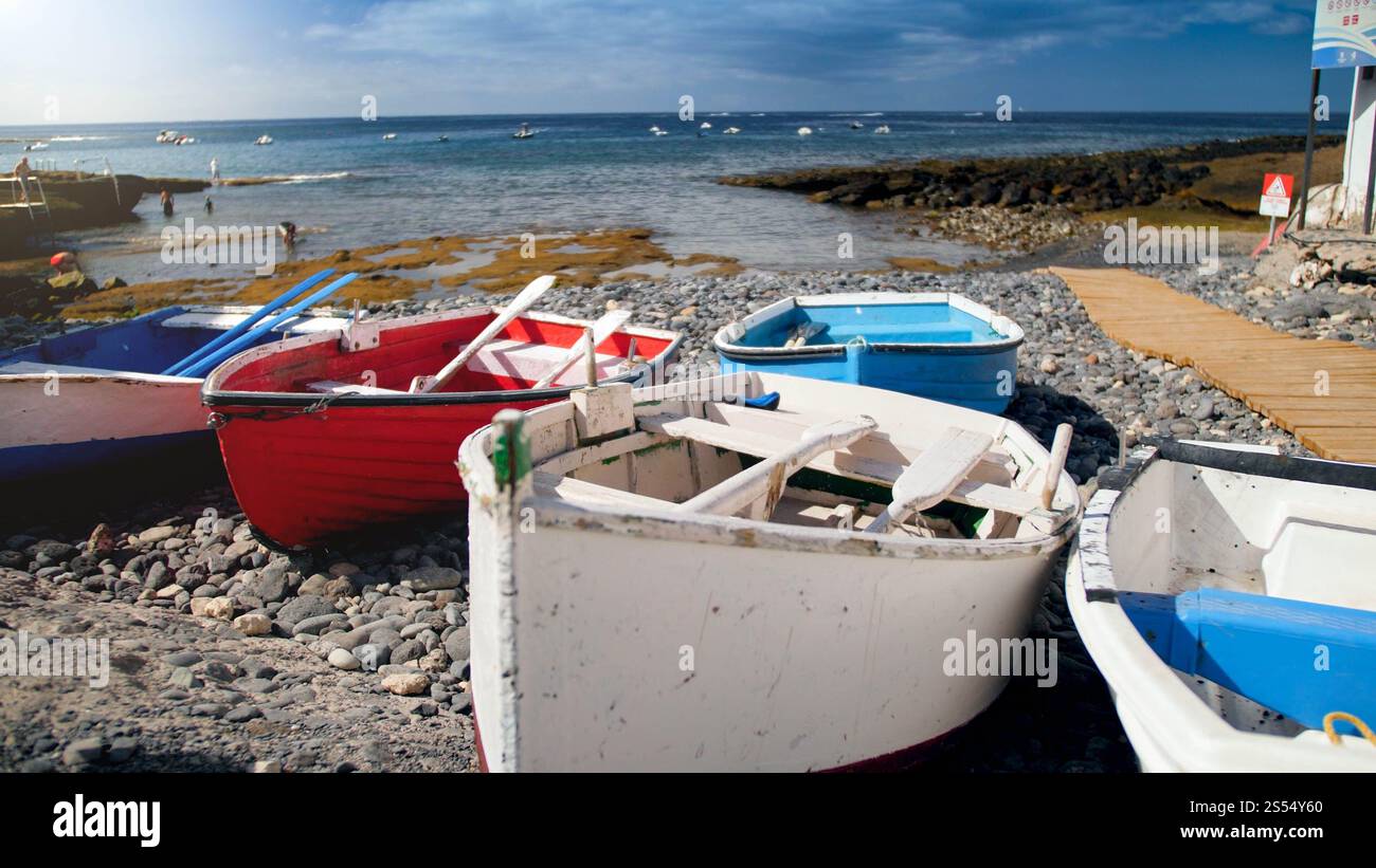 Colorful old wooden rowing boats on the sea shore at seaside village ...