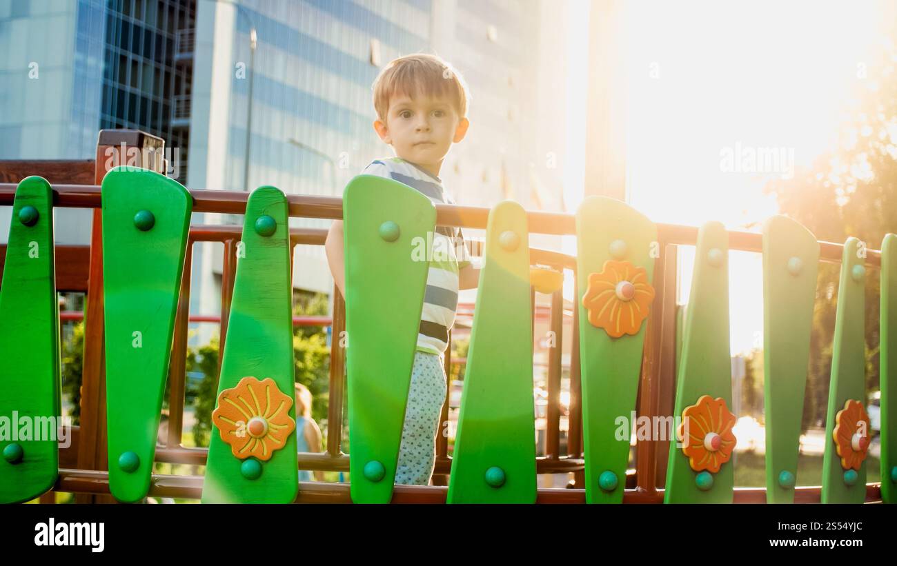 Portrait of 3 years old little boy walking and crawling on wooden ...