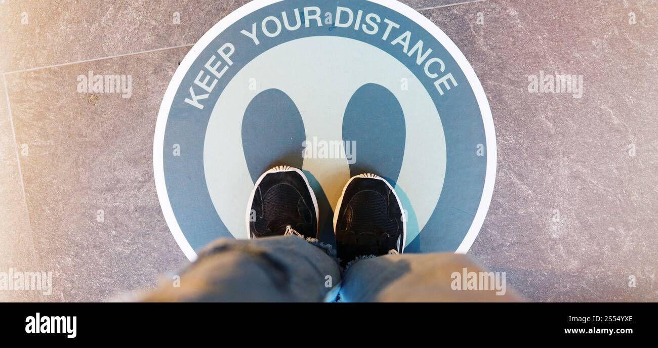 Social distancing inscription on the floor of the supermarket. keep ...