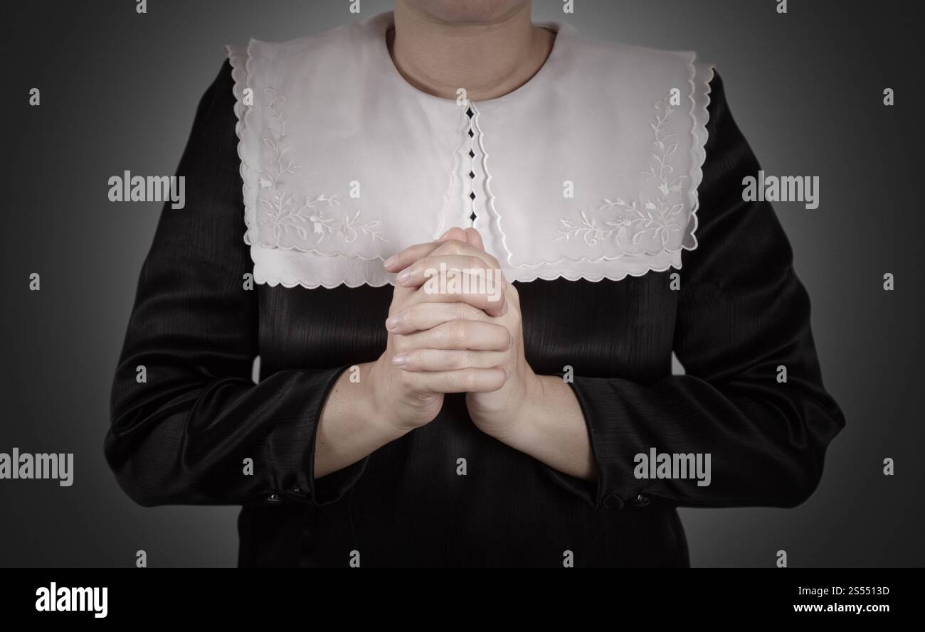 hand of nun praying on black background Stock Photo - Alamy