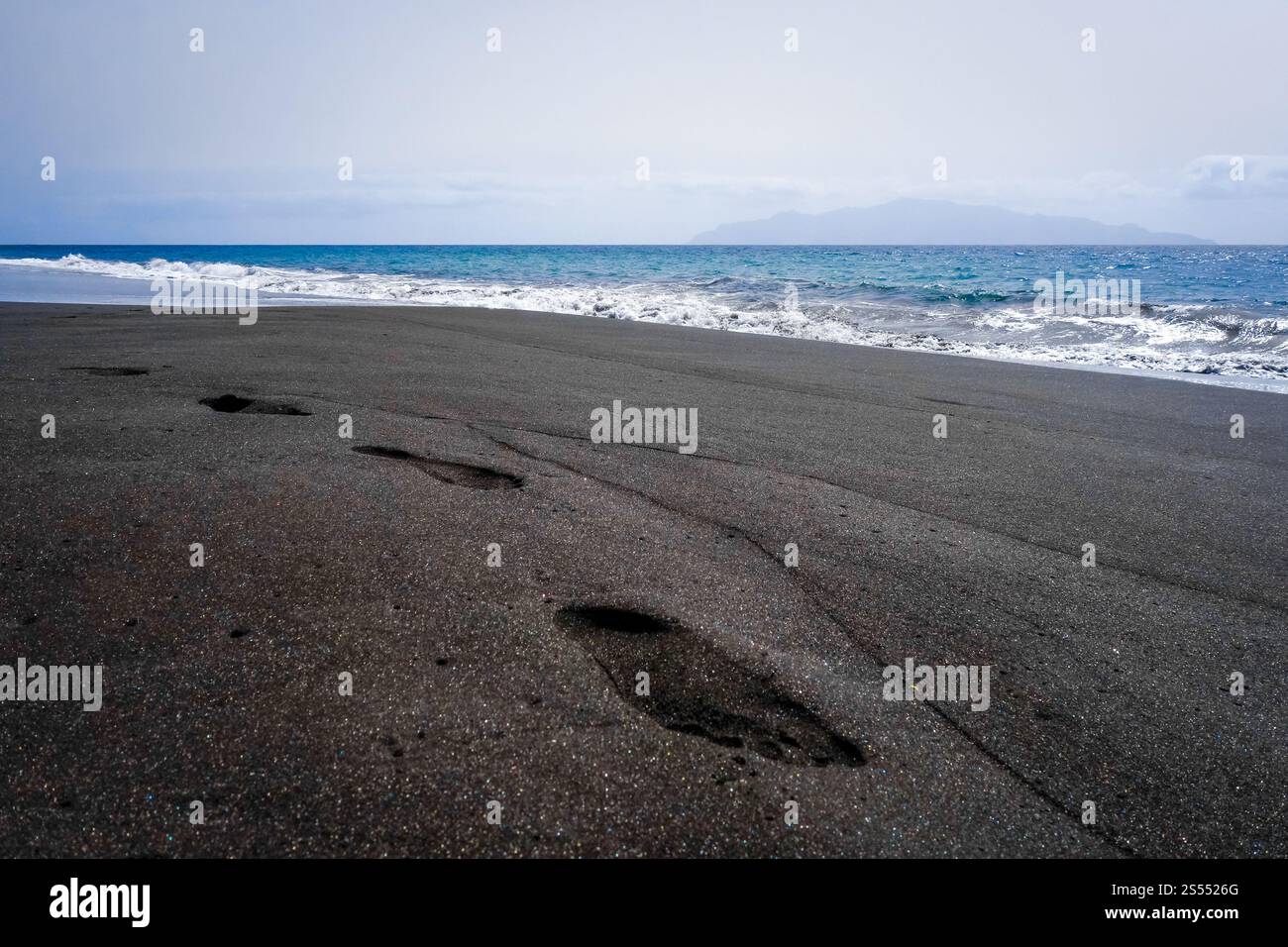 Footprints in black sand beach, Fogo Island, Cape Verde, Africa ...