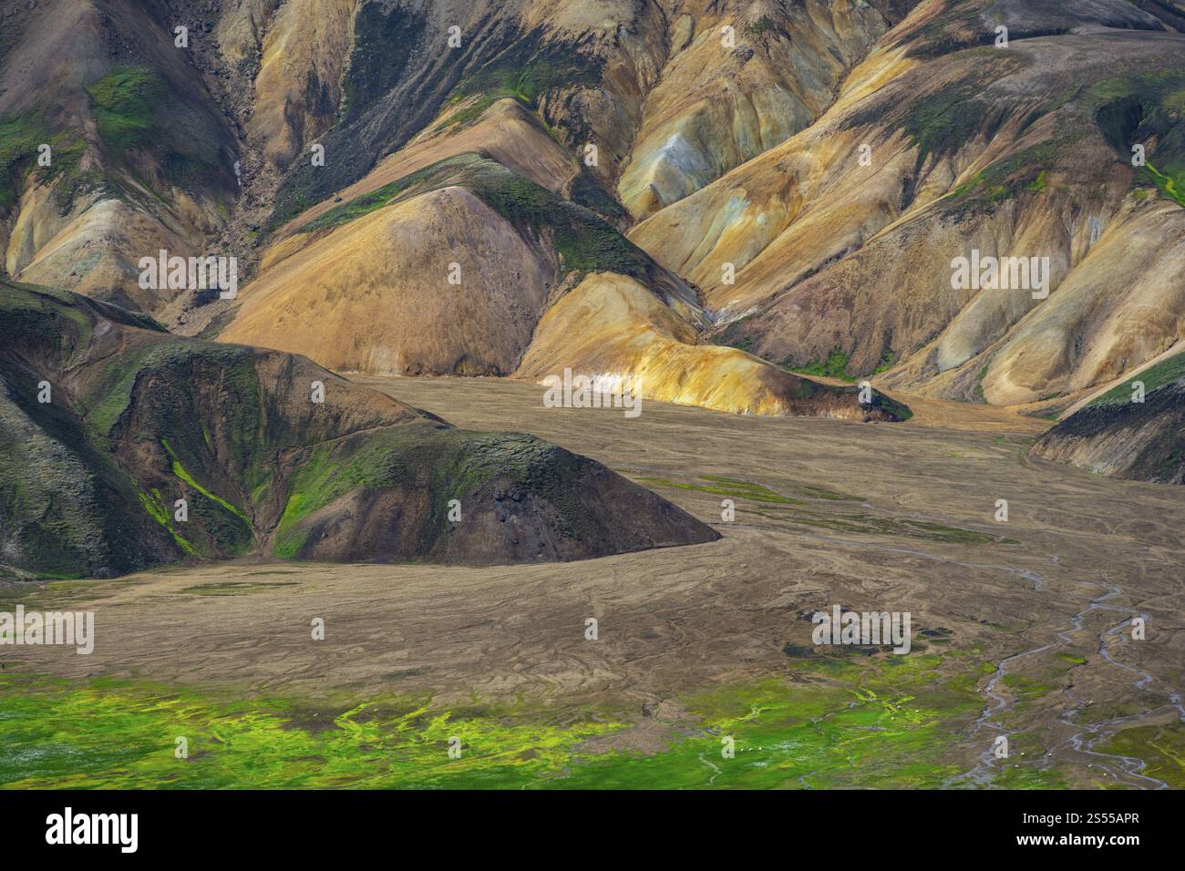 Small river between colourful rhyolite mountains, volcanic landscape ...