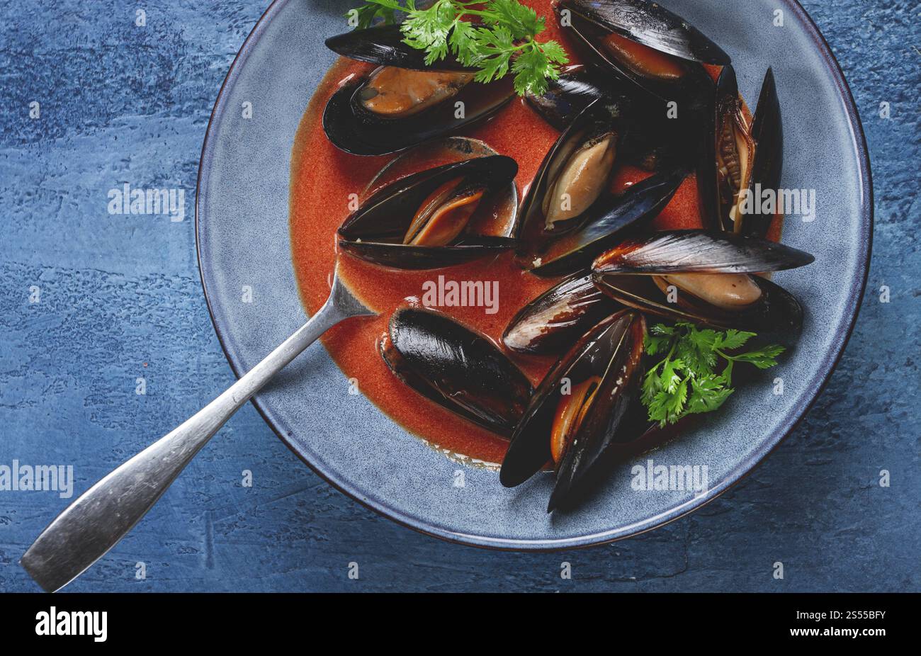 Fra Diavolo mussels, mussels in tomato sauce, Italian dish, on a blue ...