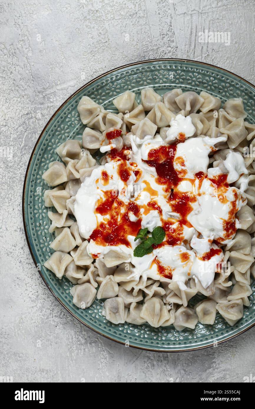 The dish features a generous serving of Turkish dumplings topped with ...