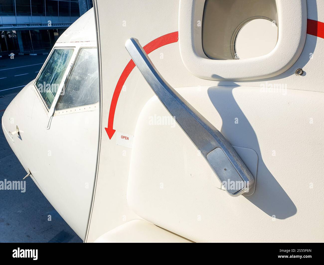 Closeup image of open door with metal handle in passenger jet airplane ...