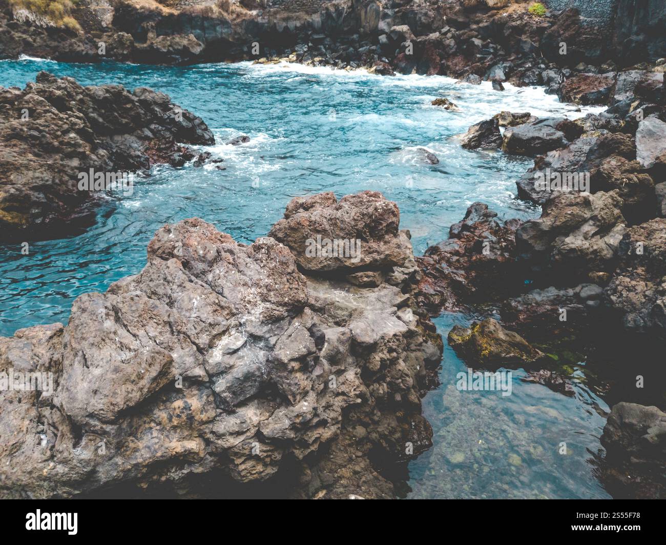 Toned photo of ocean lagoon with turquoise water surrounded by sharp ...