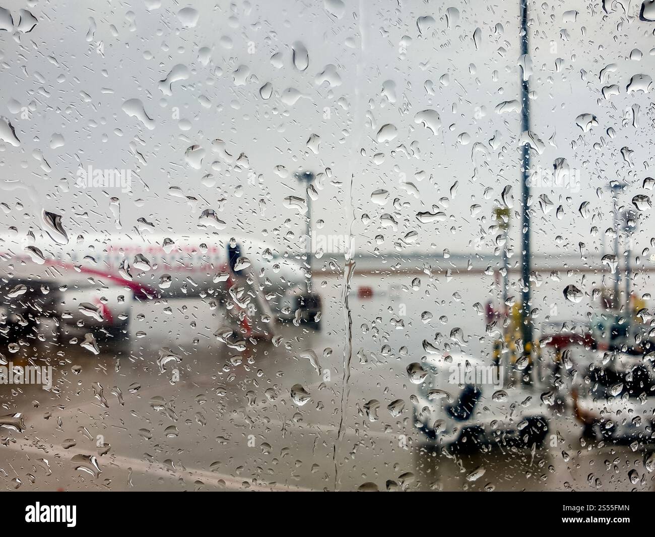 Closeup photo of rain water droplets on the wet window at airplane ...