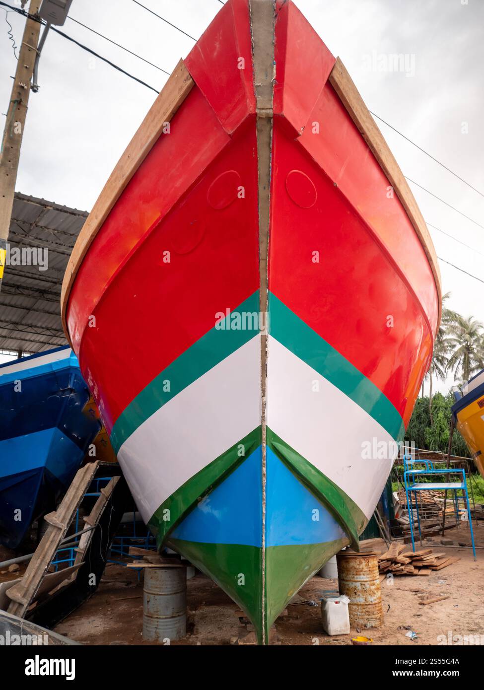 Closeup photo of beautiful colorful painted fishing boat nose in docks ...