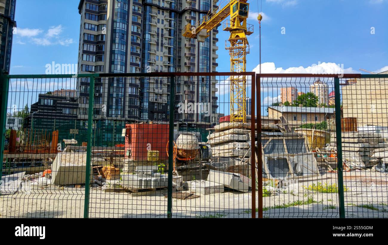 Photo of modern building construction behind the wired fence at bright ...