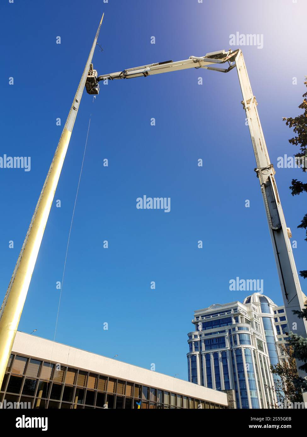 Image of machine crane doing montage works on high spire. Photo of ...