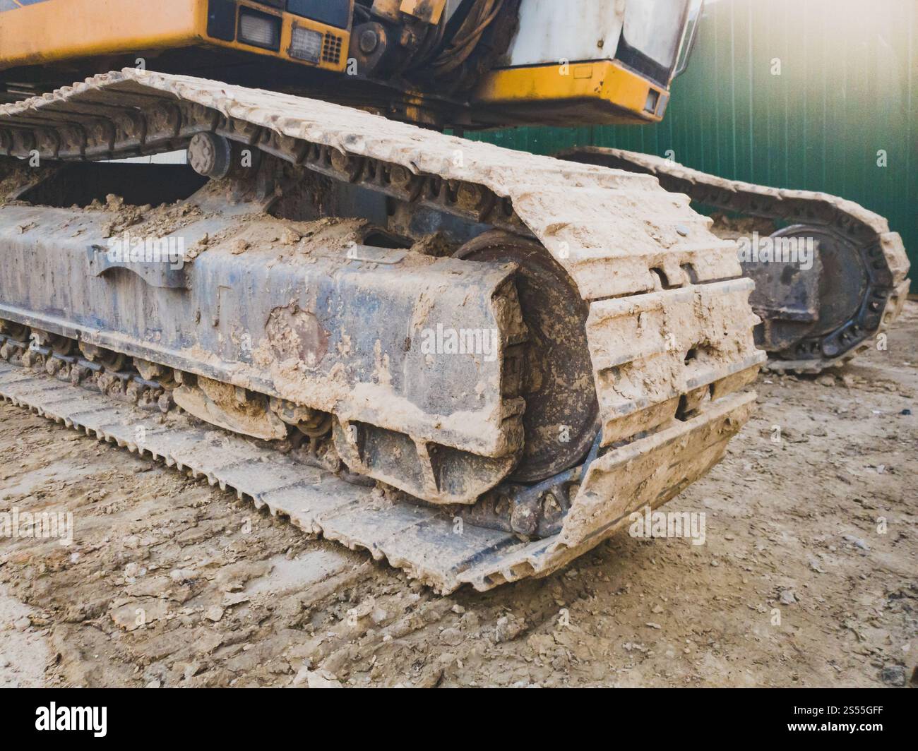 Closeup photo of dirty excavator tracks on the building site. Closeup ...