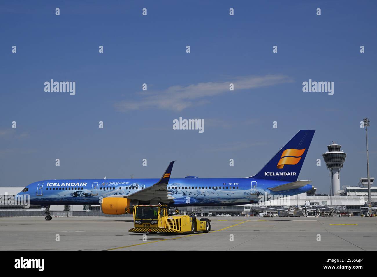 Icelandair Boeing B757 with towing vehicle and control tower taxiing in ...
