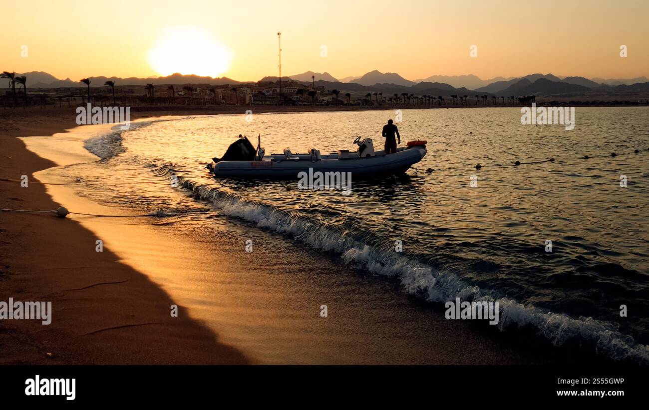 Amazing silhouette image of inflatable boat with motor rocking on calm ...