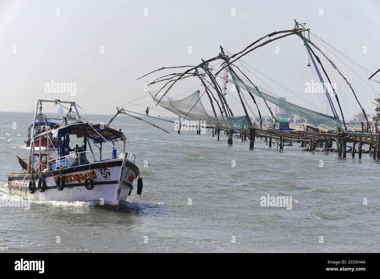 Fort Kochi, Kochi, Kerala, South India, India, Asia, Small boat passes ...