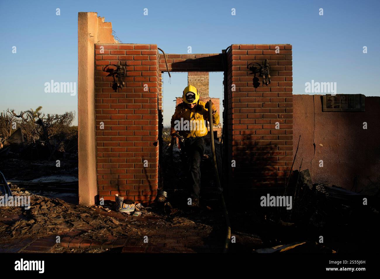 Apple Valley Fire District firefighter Wyatt Cortez walks through a ...