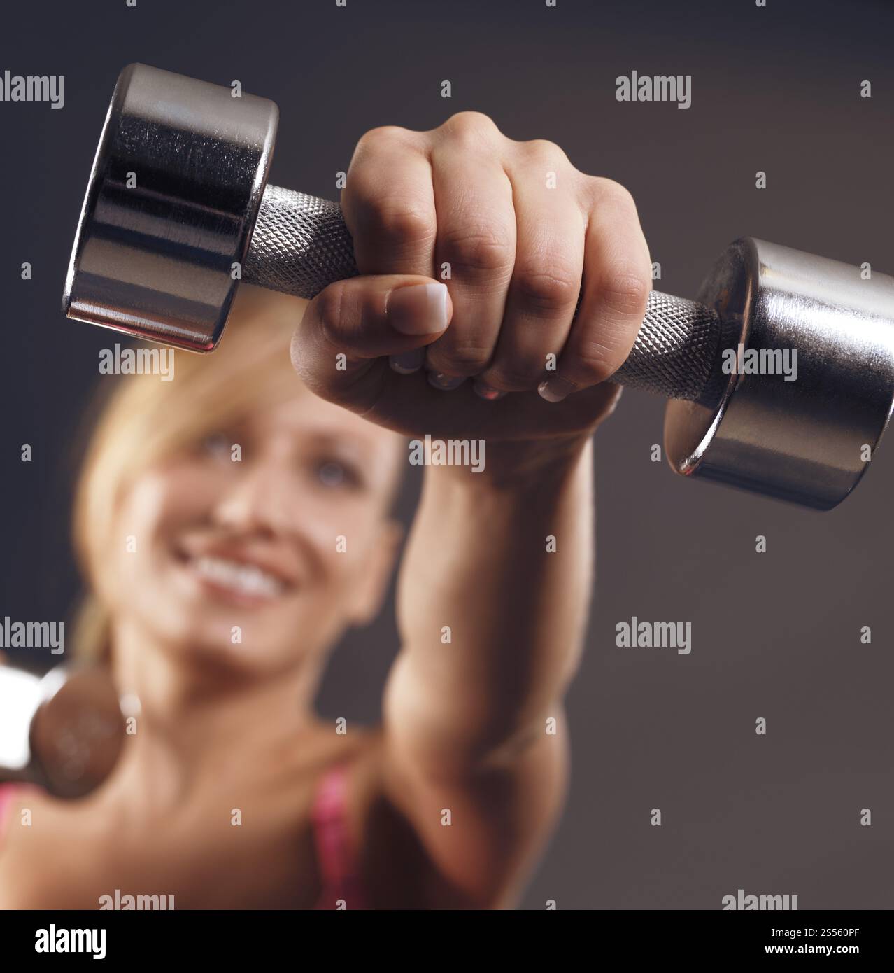 Young smiling woman doing cardio fitness workout with weights, closeup ...