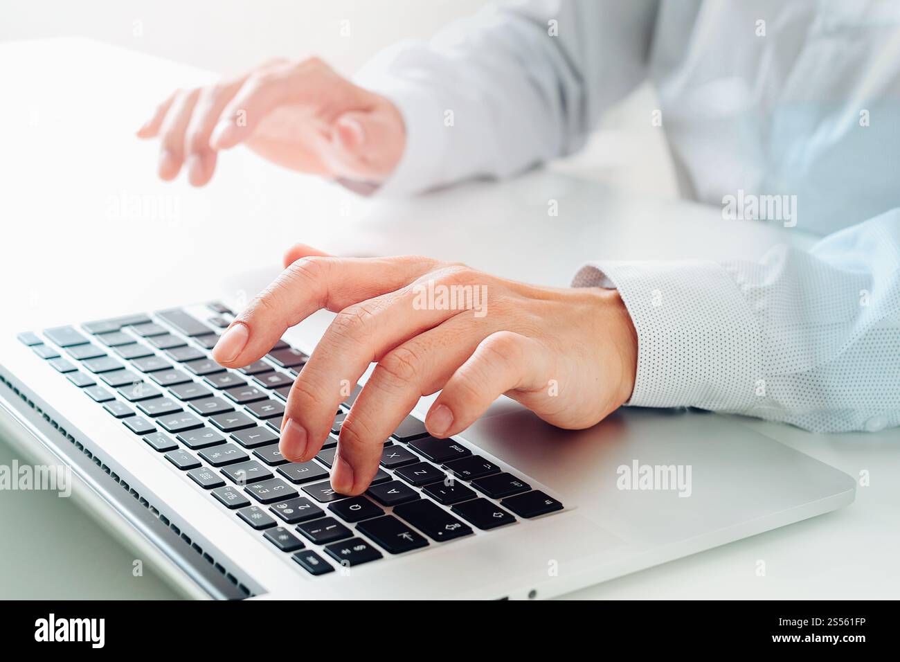 close up of businessman typing keyboard with laptop computer on white ...