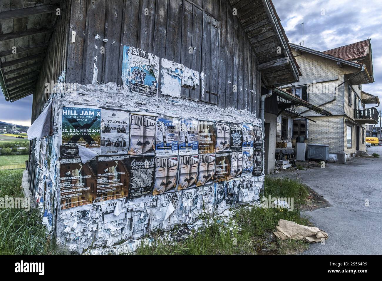 Wooden wall of the outbuilding that was pasted over with event posters ...