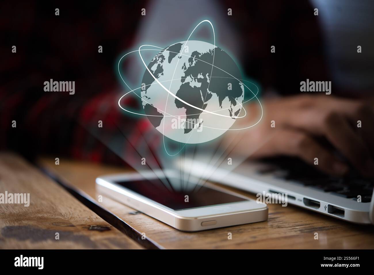 Women work on laptop with global exposure on smartphone screen. Digital ...