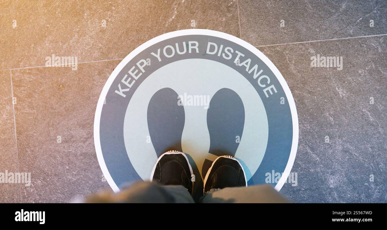 Social distancing inscription on the floor of the supermarket. keep ...