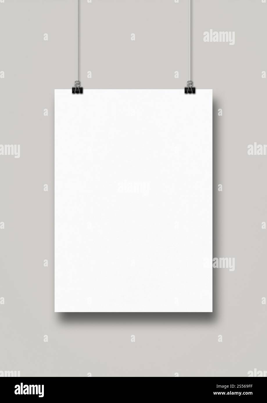 White poster hanging on a clean wall with clips. Blank mockup template ...