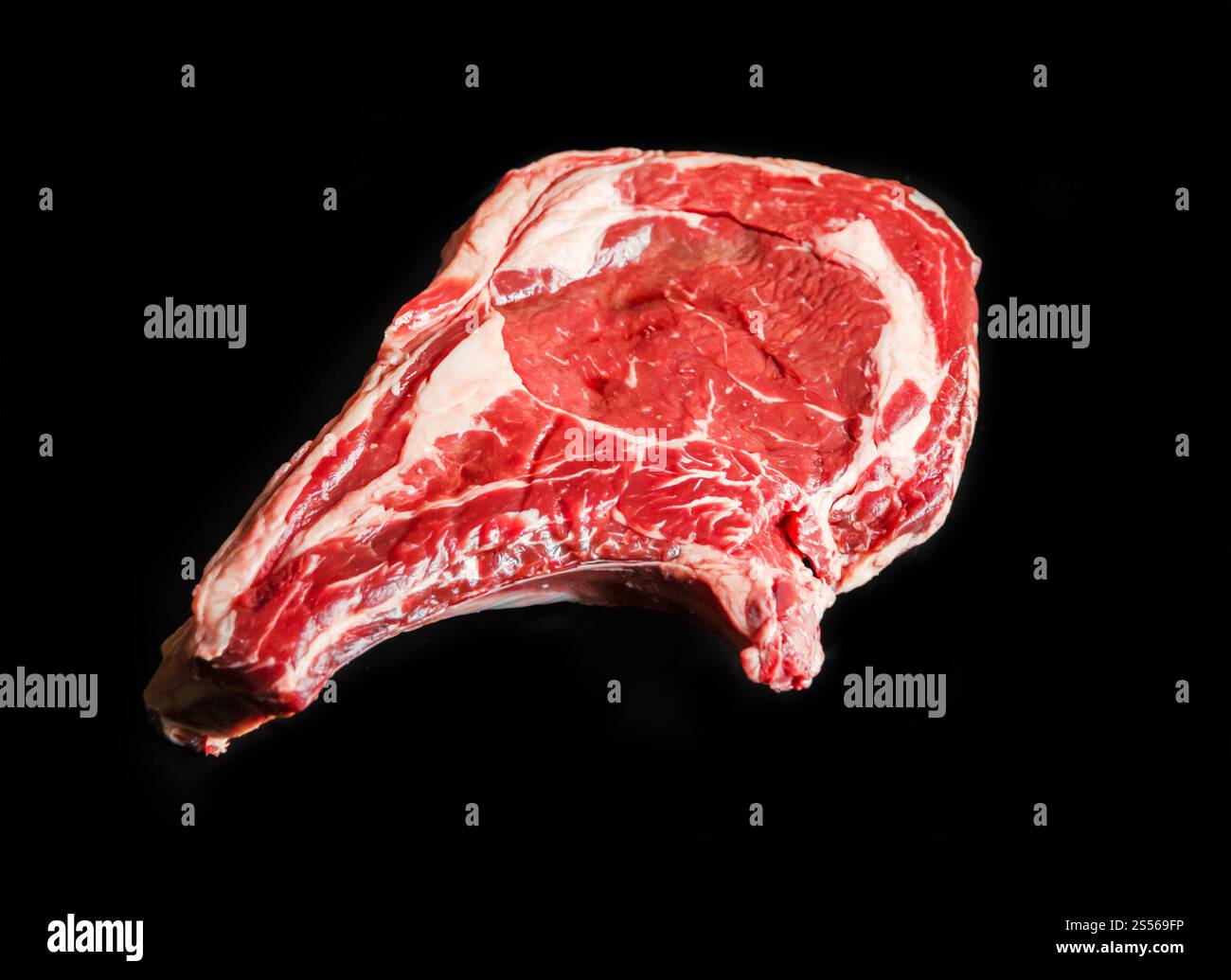 Raw beef prime rib isolated on black background. Top view. Beef prime ...