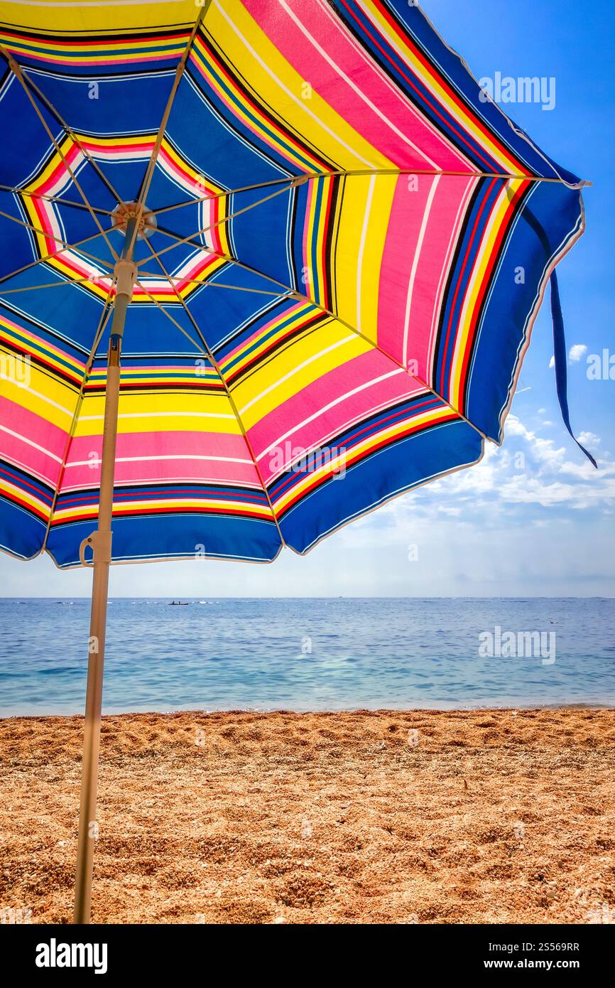 Colorful umbrella close-up view on a tropical beach. Colorful umbrella ...