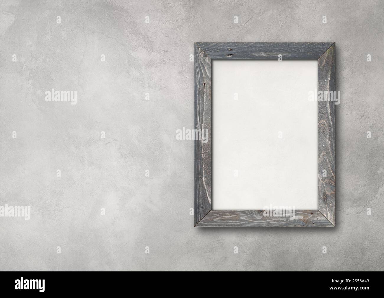 Old grey rustic wooden picture frame hanging on a concrete wall ...
