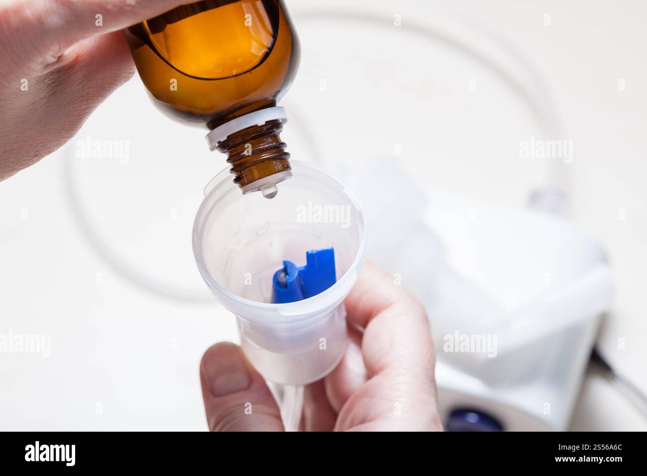 Woman dripping medicine from vial hi-res stock photography and images - Alamy