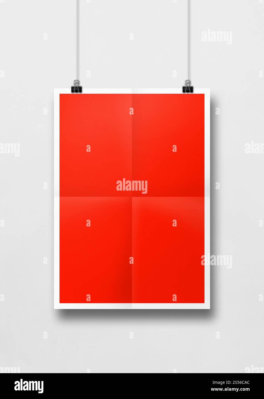 Red folded poster hanging on a white wall with clips. Blank mockup ...