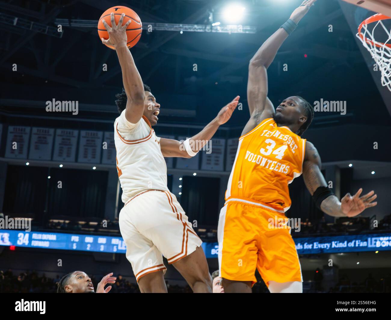 Texas guard Julian Larry, left, goes up for a shot against Tennessee ...