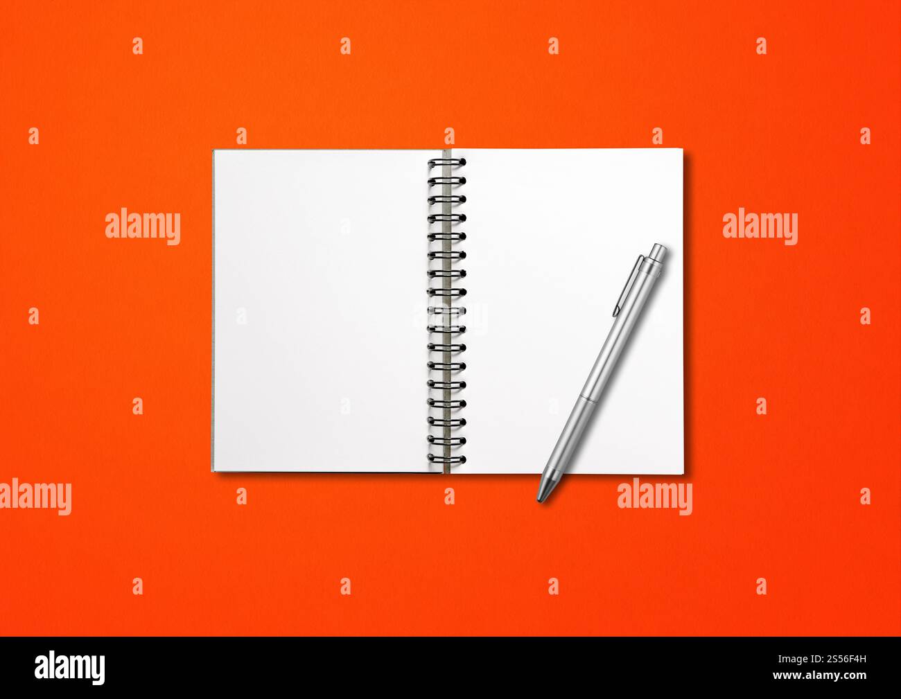 Blank open spiral notebook mockup and pen isolated on red background ...