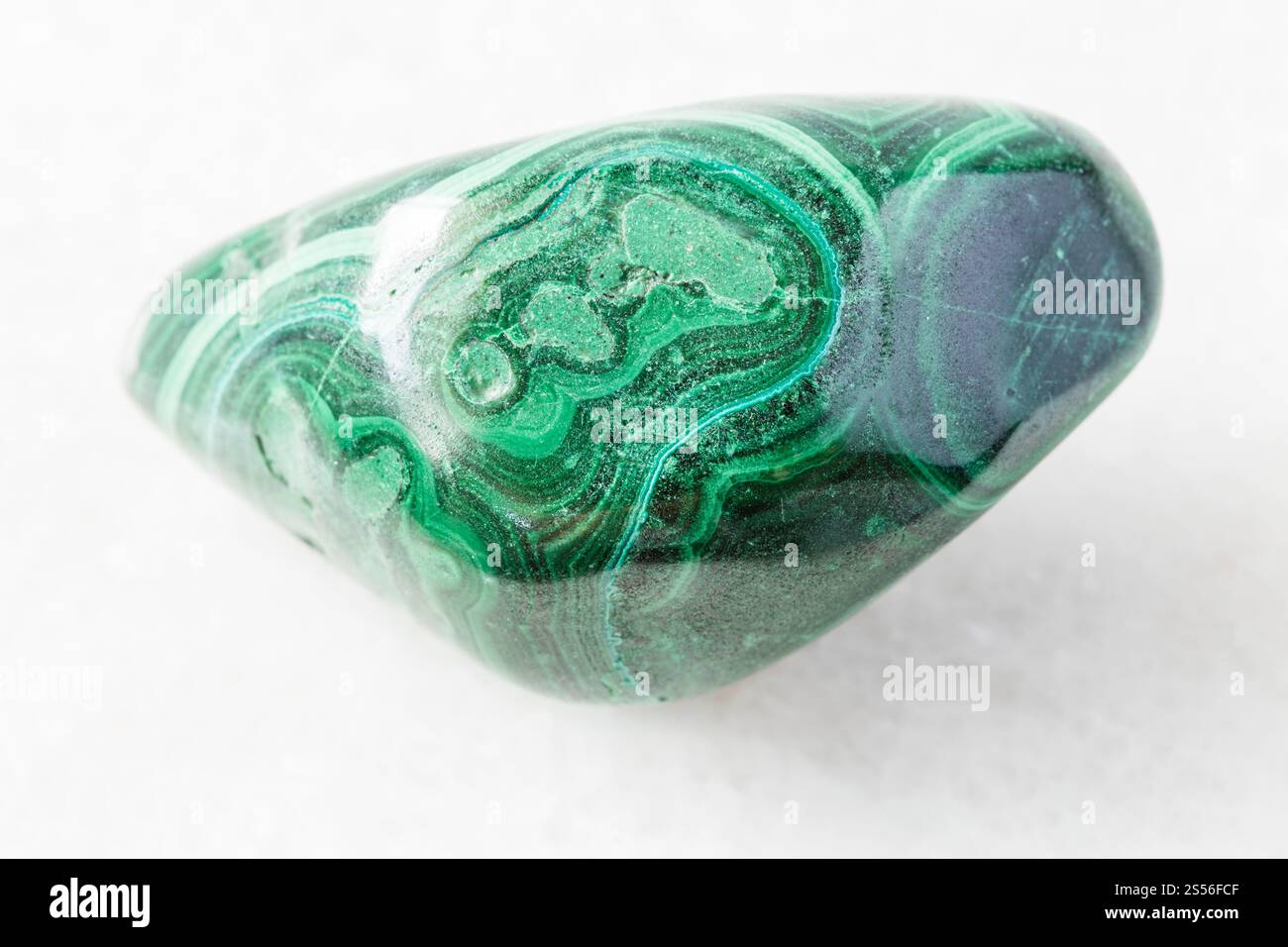 closeup of sample of natural mineral from geological collection - tumbled Malachite rock on ...