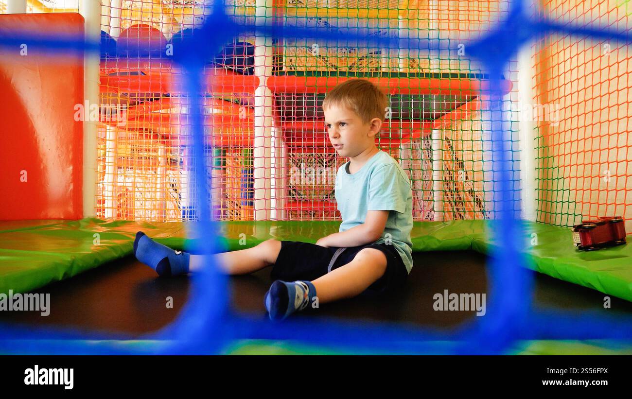 Upset little boy feeling sad while playing on playground with ...