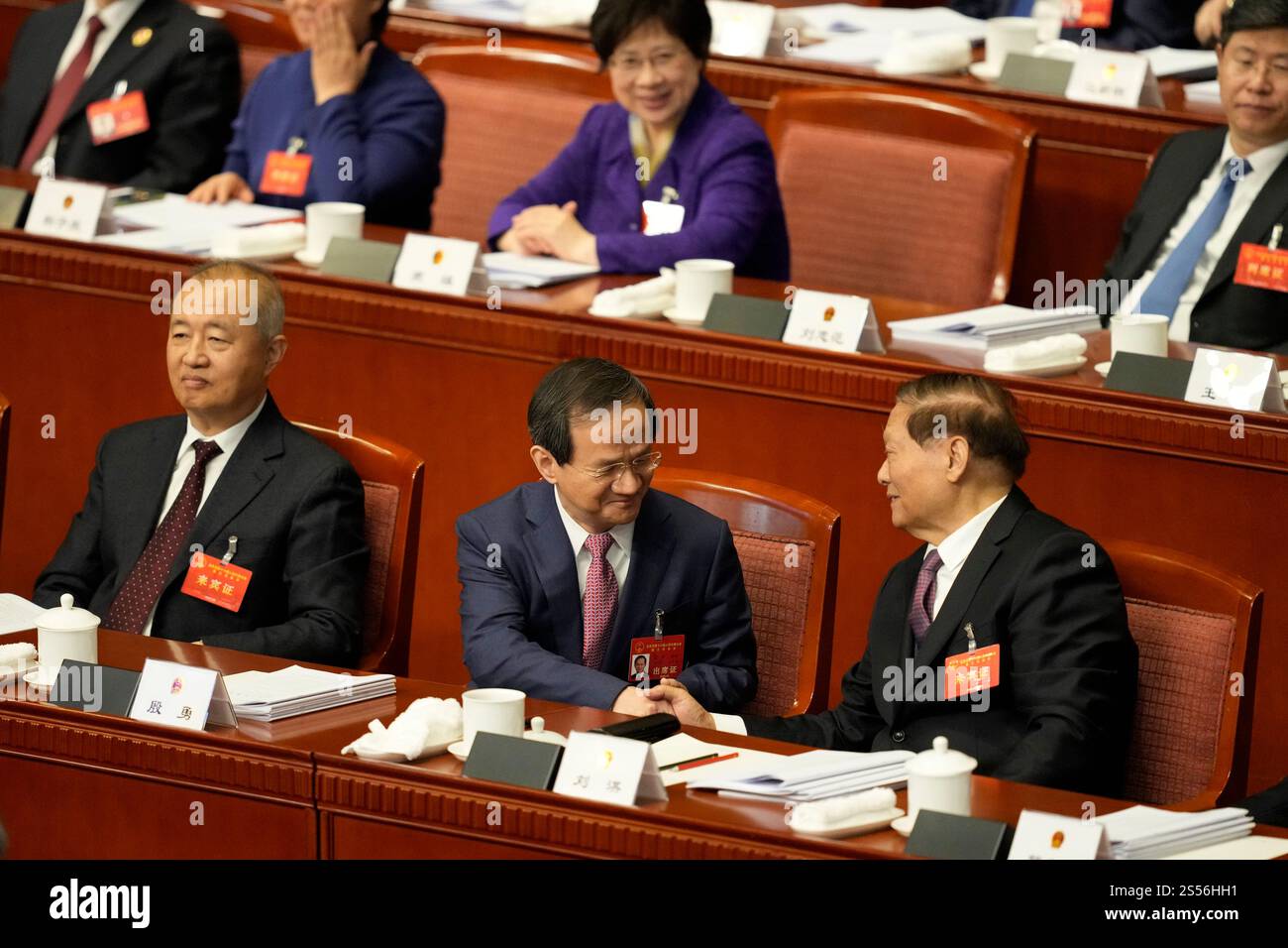 Beijing Mayor Yin Yong, center, shakes hands with former party ...