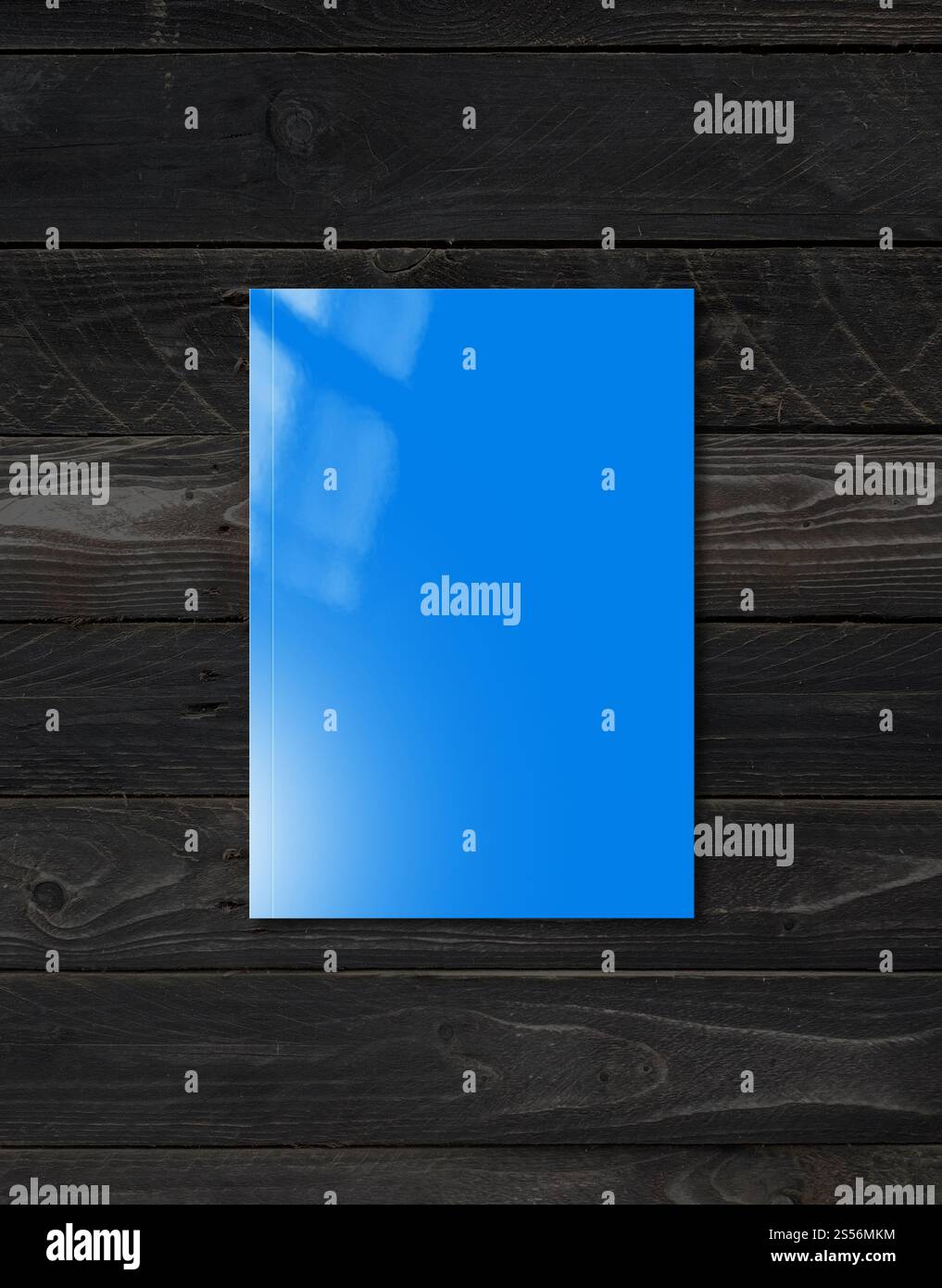 Blue booklet cover isolated on black wood background, mockup template ...