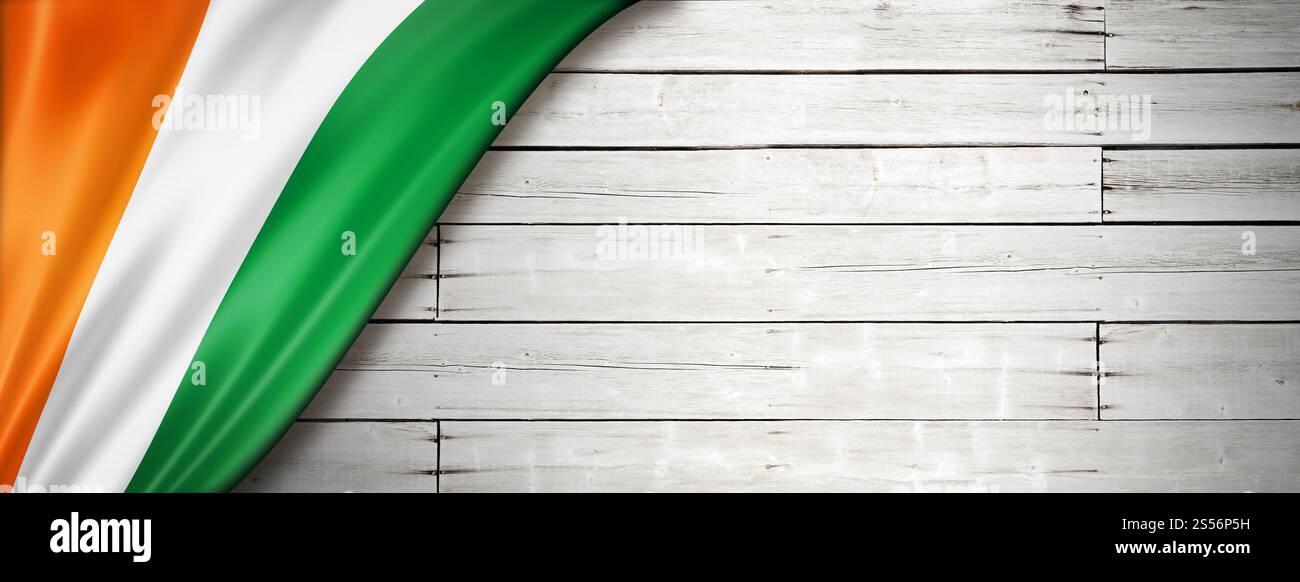 Ivory Coast flag on old white wall. Horizontal panoramic banner ...
