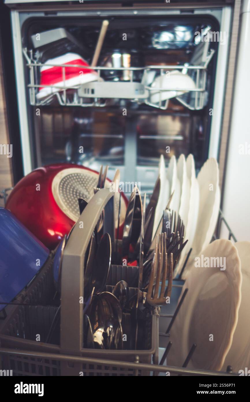 Open dishwasher in a kitchen. Closeup view. Open dishwasher in a ...